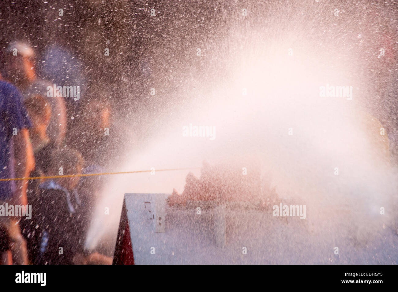 Water spray over a house fire demonstration with wooden flame for ...