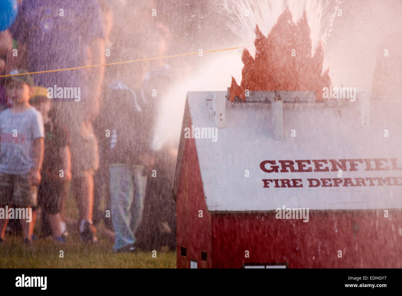 A little boy using the Greenfield WI Fire Department hose to extinuish ...