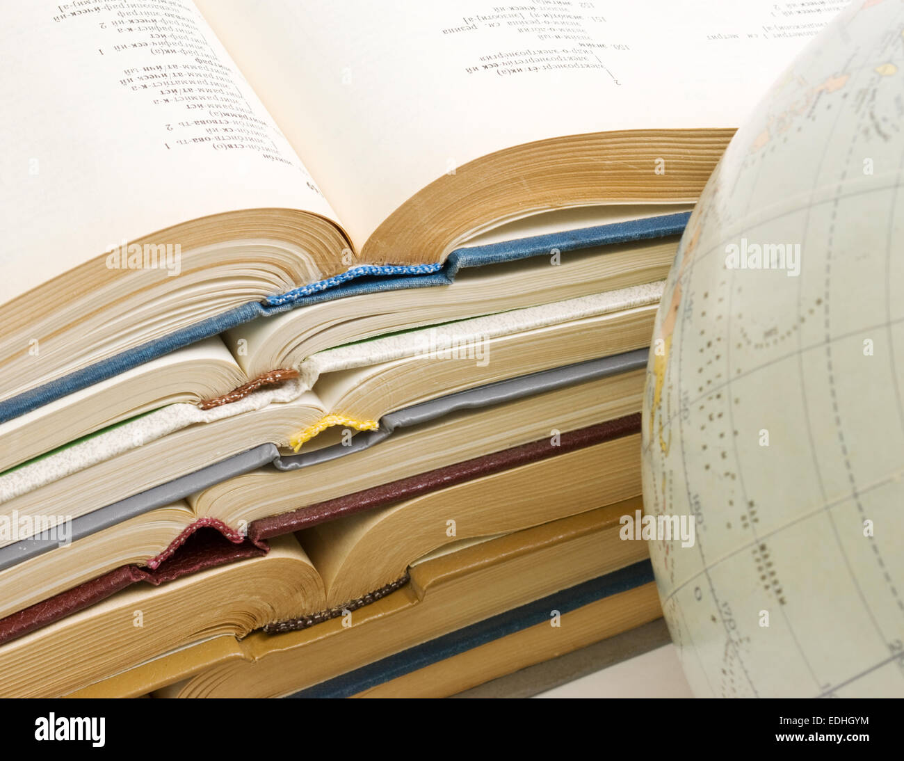 stack of open books and Globe isolated on a white background Stock ...