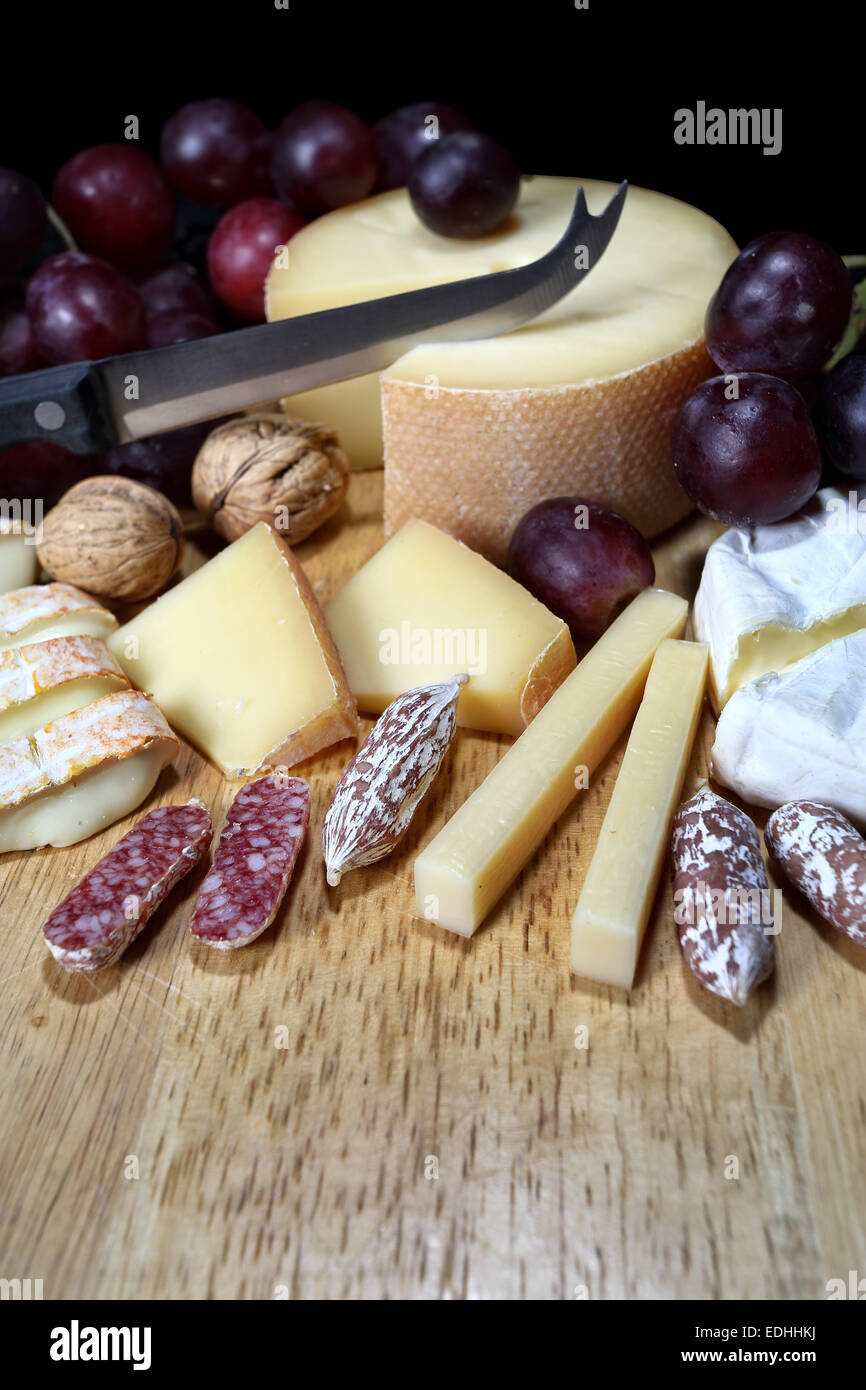 Exquisite mold cheeses on a black background Stock Photo - Alamy