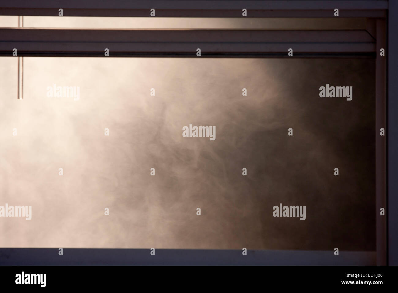 Smoke inside a house seen through a window Stock Photo - Alamy