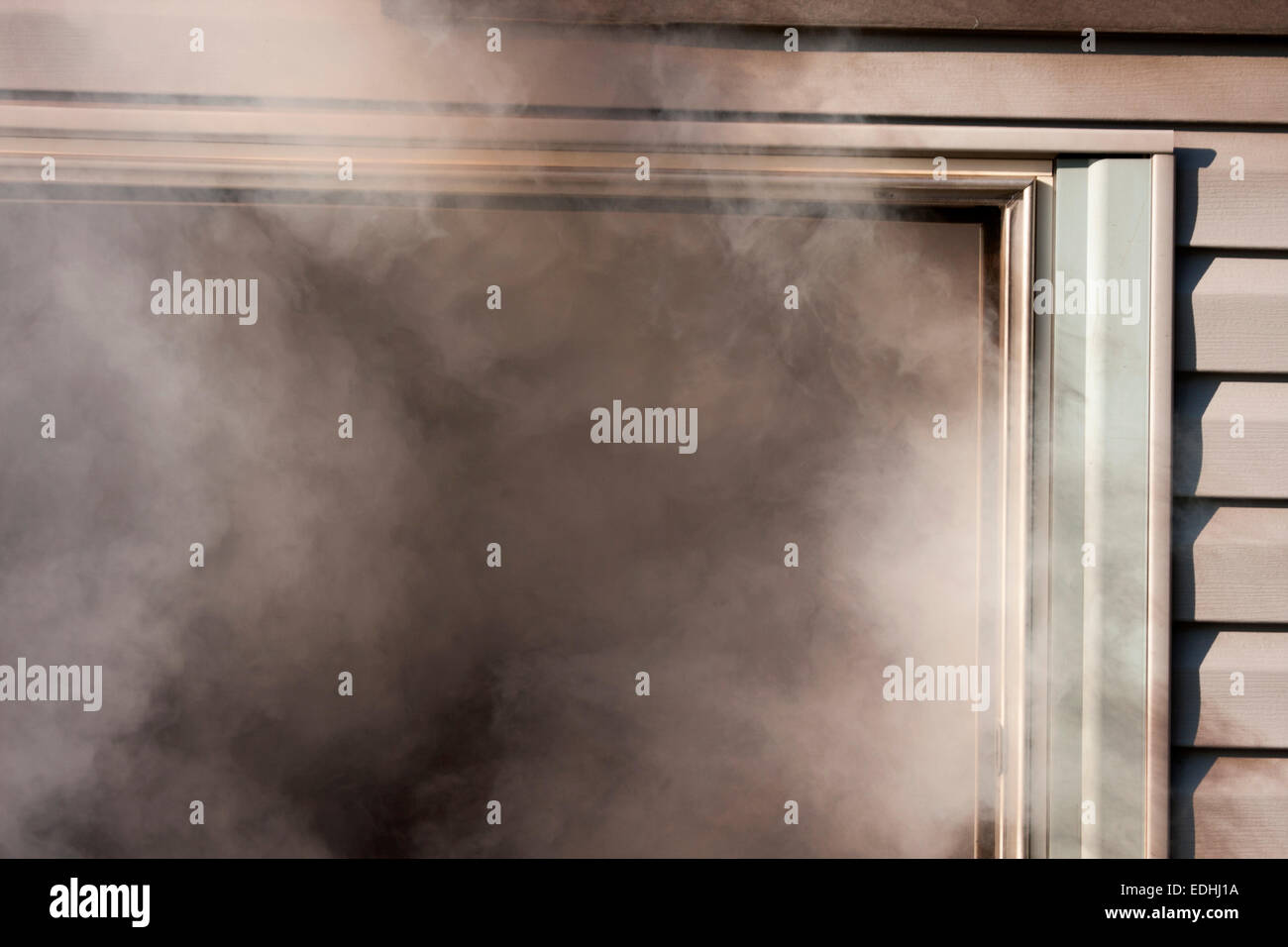 Smoke exiting a window Stock Photo - Alamy