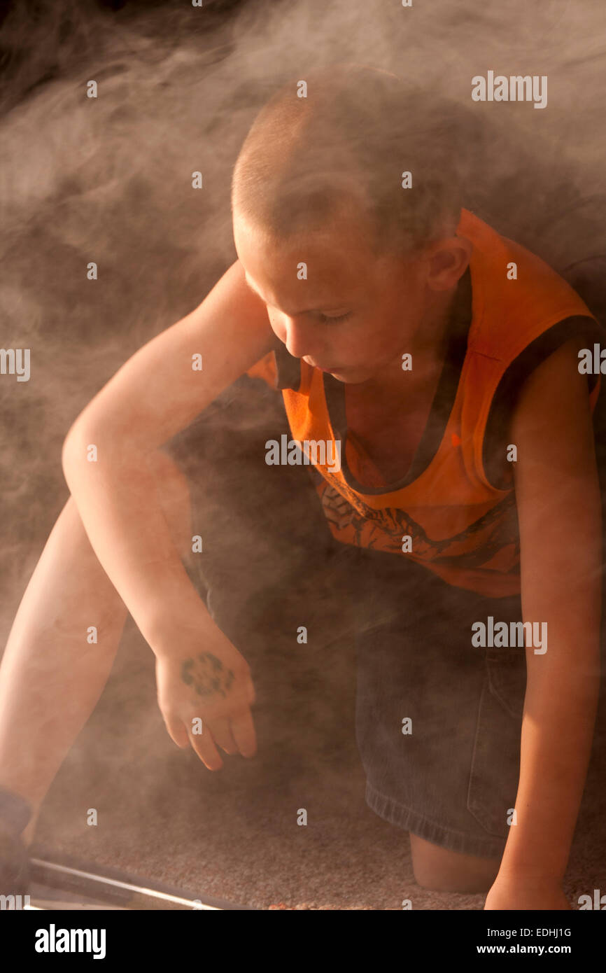 A boy exiting a smoke filled survive alive trailer room Stock Photo - Alamy