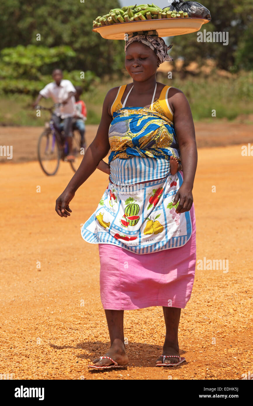 Hawker carrying goods on her head, rural Ghana, Africa Stock Photo - Alamy
