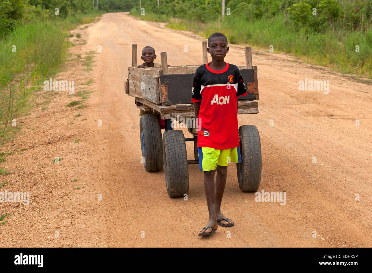 Children pulling cart on rural road, Greater Accra, Ghana, Africa Stock ...