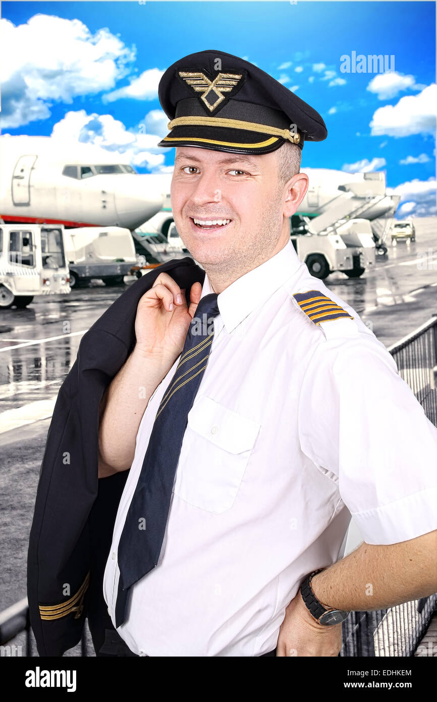 Elegant smiling pilot at the airport in beautiful day Stock Photo - Alamy