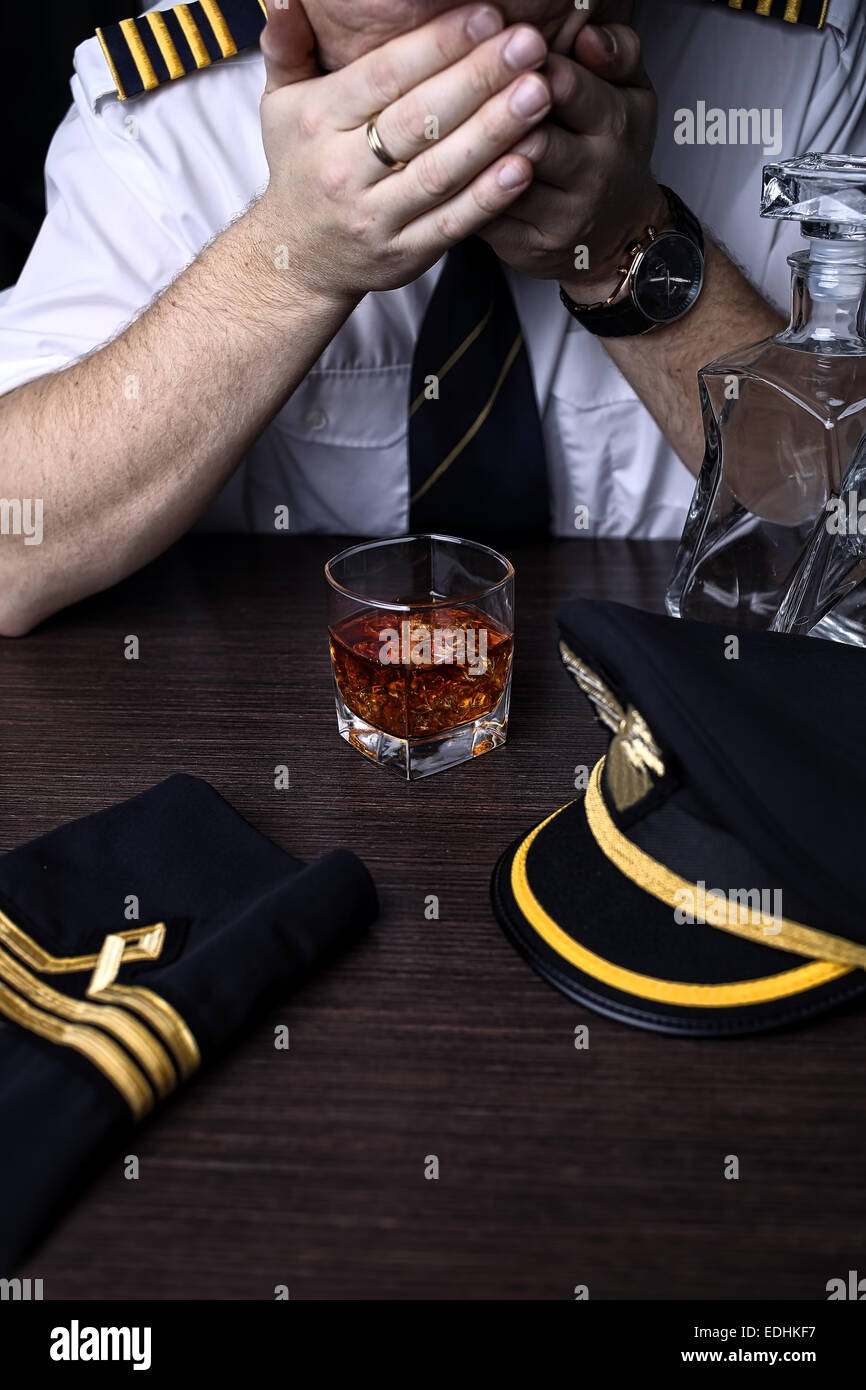 Desperate and plunged pilot drink alcohol Stock Photo - Alamy