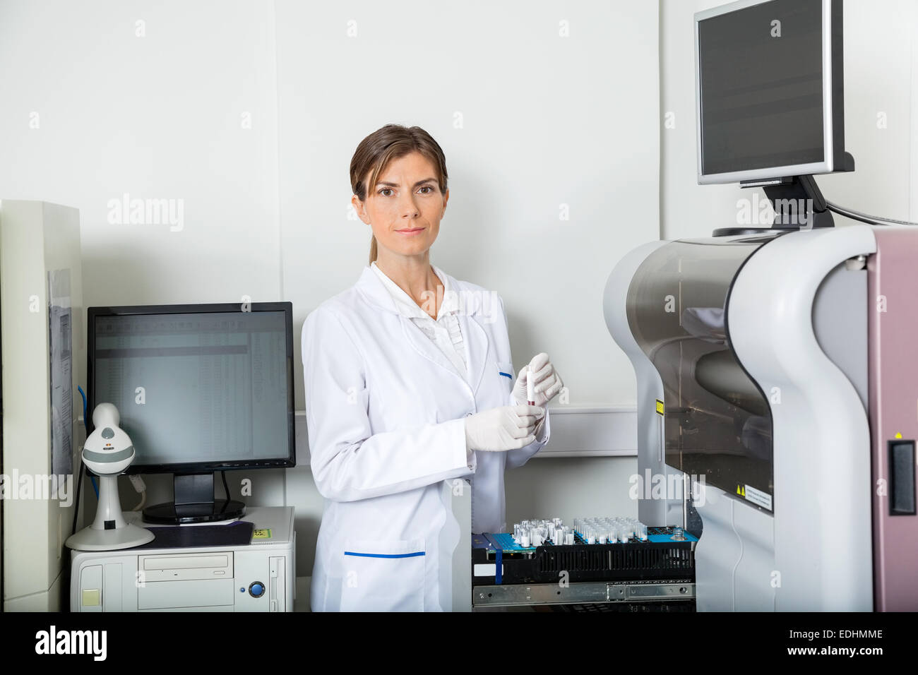 Scientist Loading Coagulation Analyzer With Samples Stock Photo - Alamy