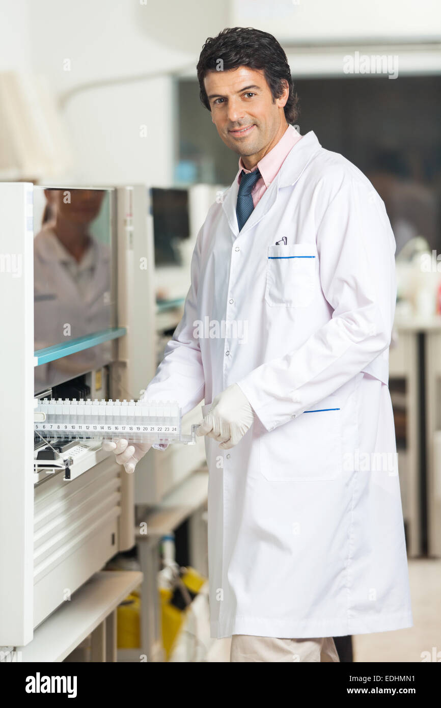 Technician Loading Samples In Analyzer Stock Photo - Alamy