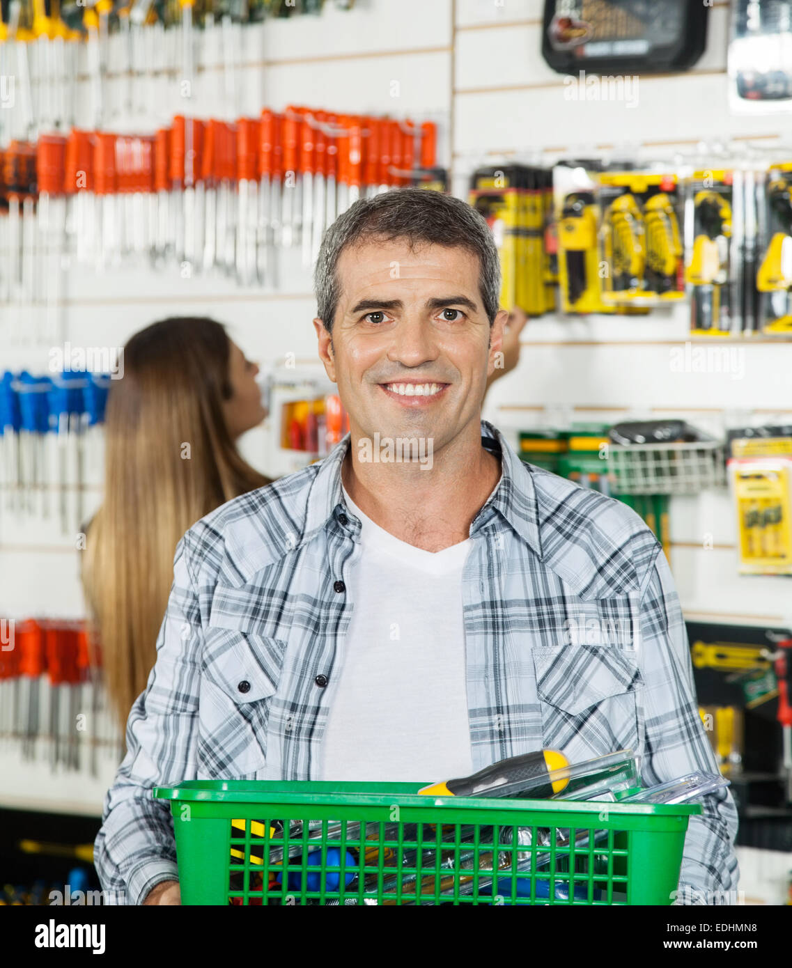 Man Carrying Basket Full Of Tools In Store Stock Photo - Alamy