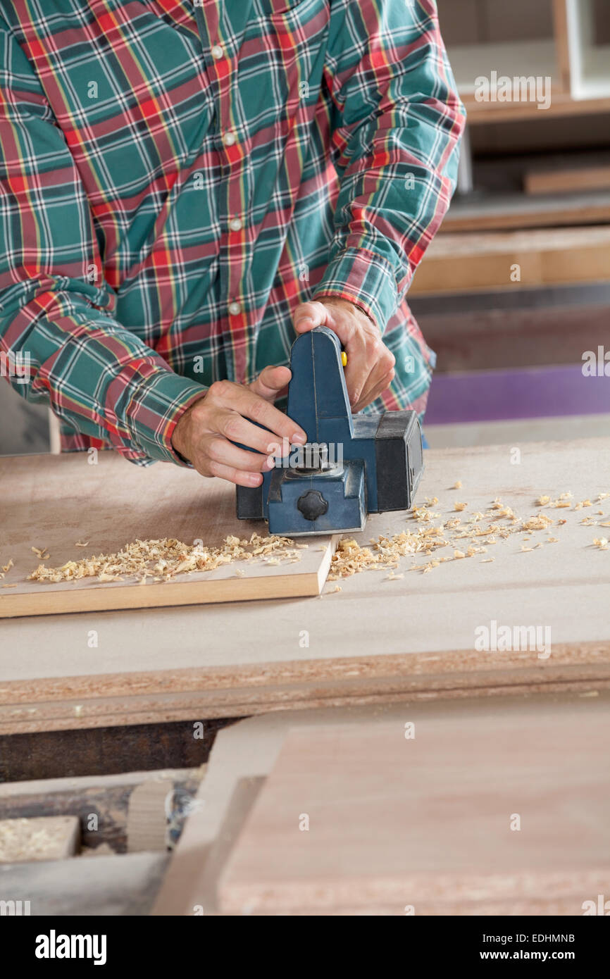 Worker Using Electric Planer On Wood Stock Photo - Alamy
