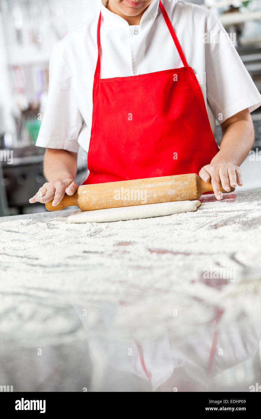Chef Rolling Dough At Messy Counter Stock Photo - Alamy