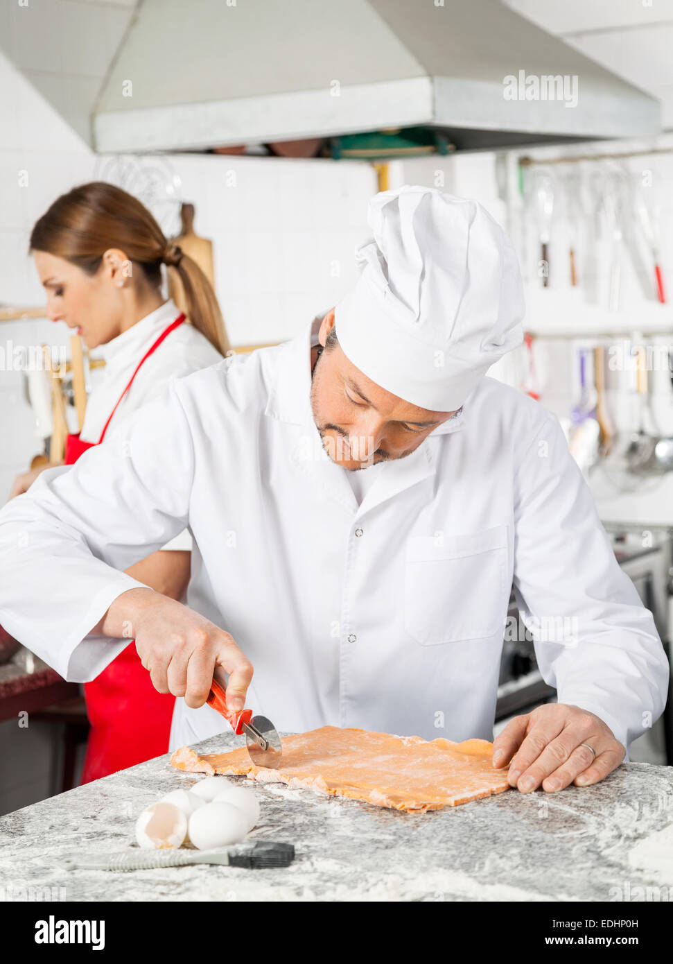 Woman cooking pasta in kitchen hi-res stock photography and images - Alamy