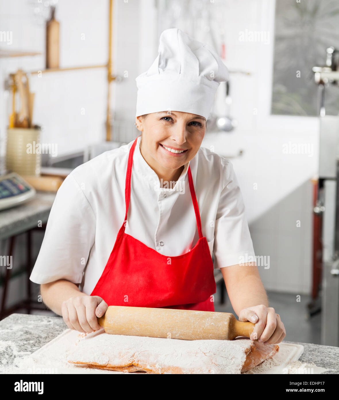 Smiling Female Chef Rolling Pasta Sheet At Counter Stock Photo - Alamy