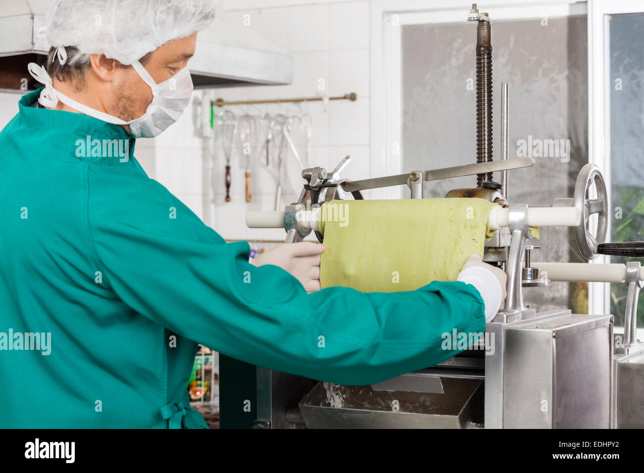 Chef Preparing Green Pasta Sheet In Machine Stock Photo - Alamy
