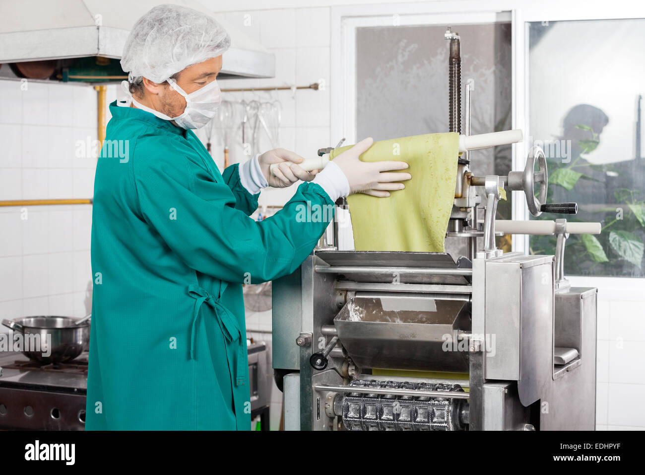 Chef Wrapping Green Pasta Sheet On Rolling Pin Into Machine Stock Photo ...