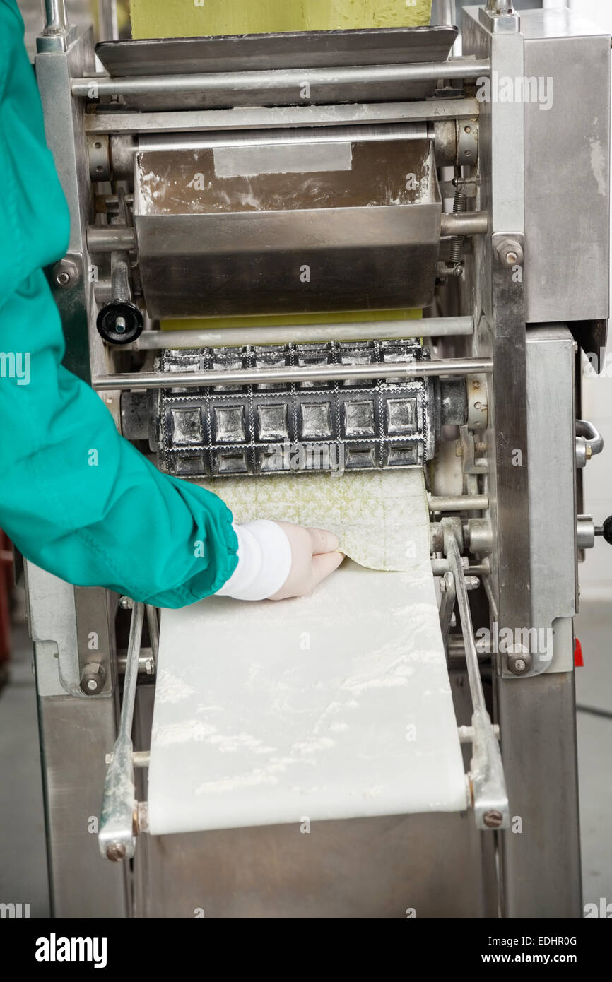 Chef Removing Ravioli Pasta From Machine Stock Photo - Alamy