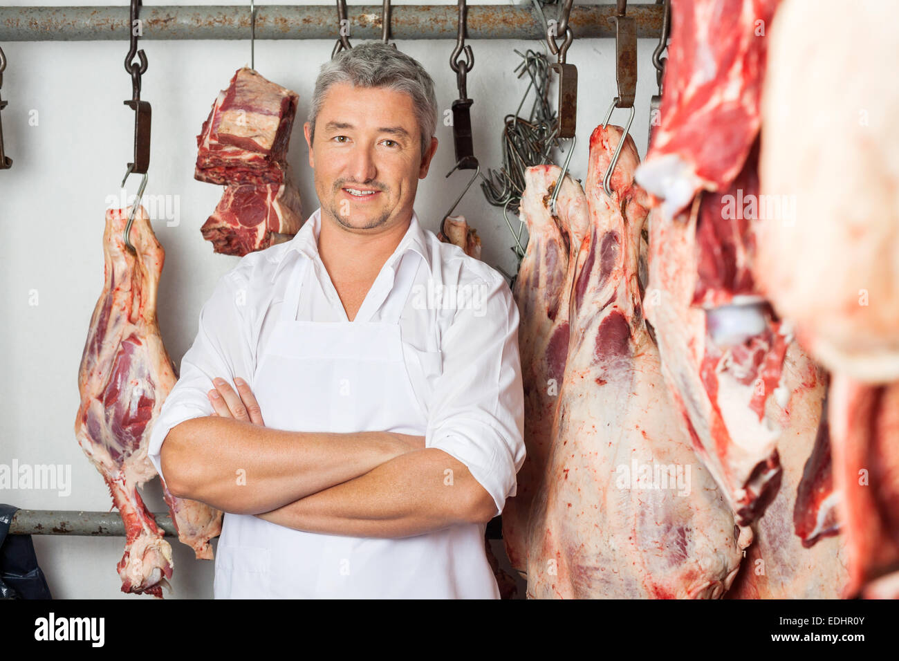 Butcher Standing Arms Crossed In Butchery Stock Photo - Alamy