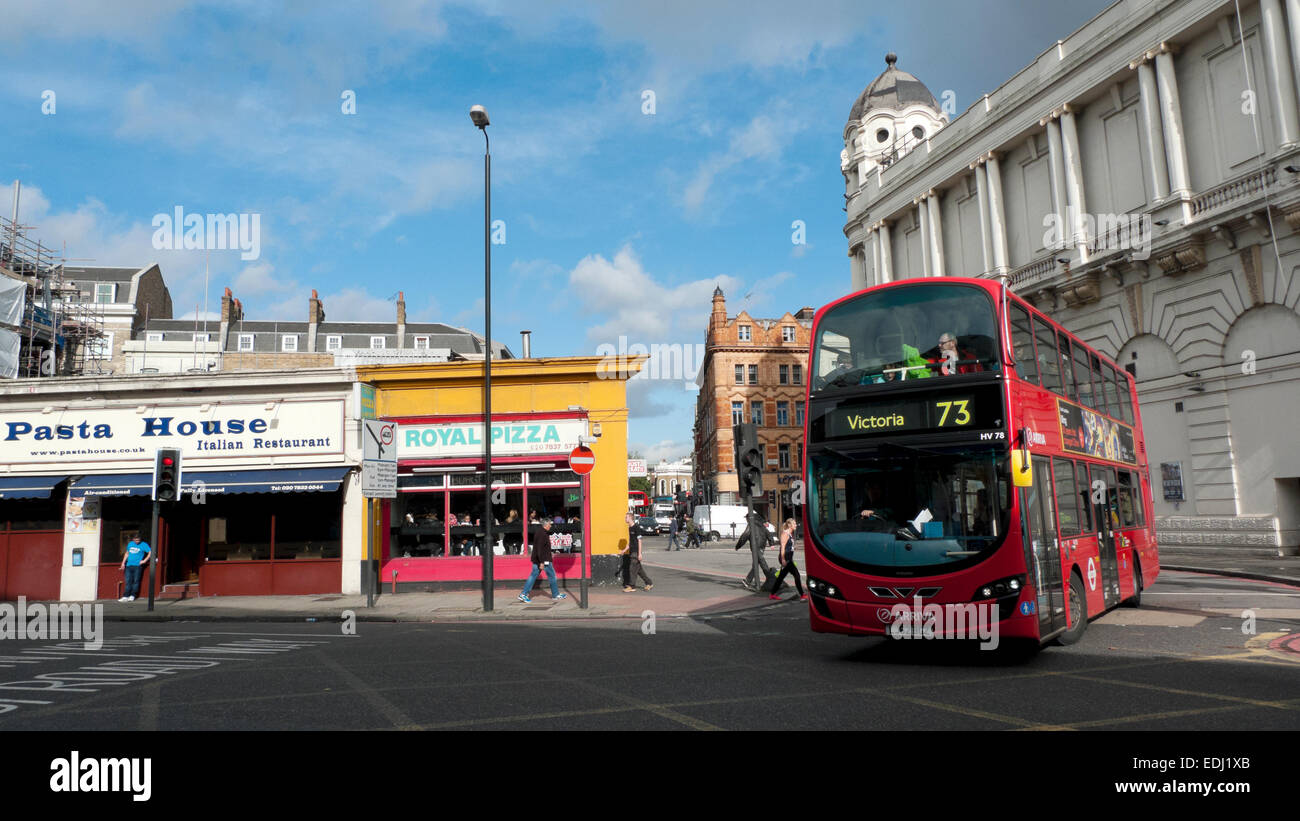 A double-decker 73 Victoria bus turns the corner at King's Cross Bridge ...