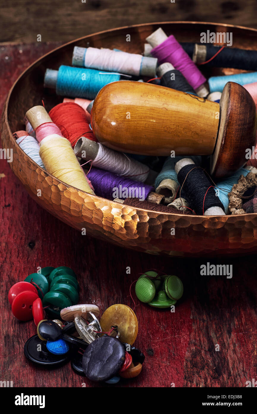 coils of different sewing threads in bronze bowl Stock Photo - Alamy