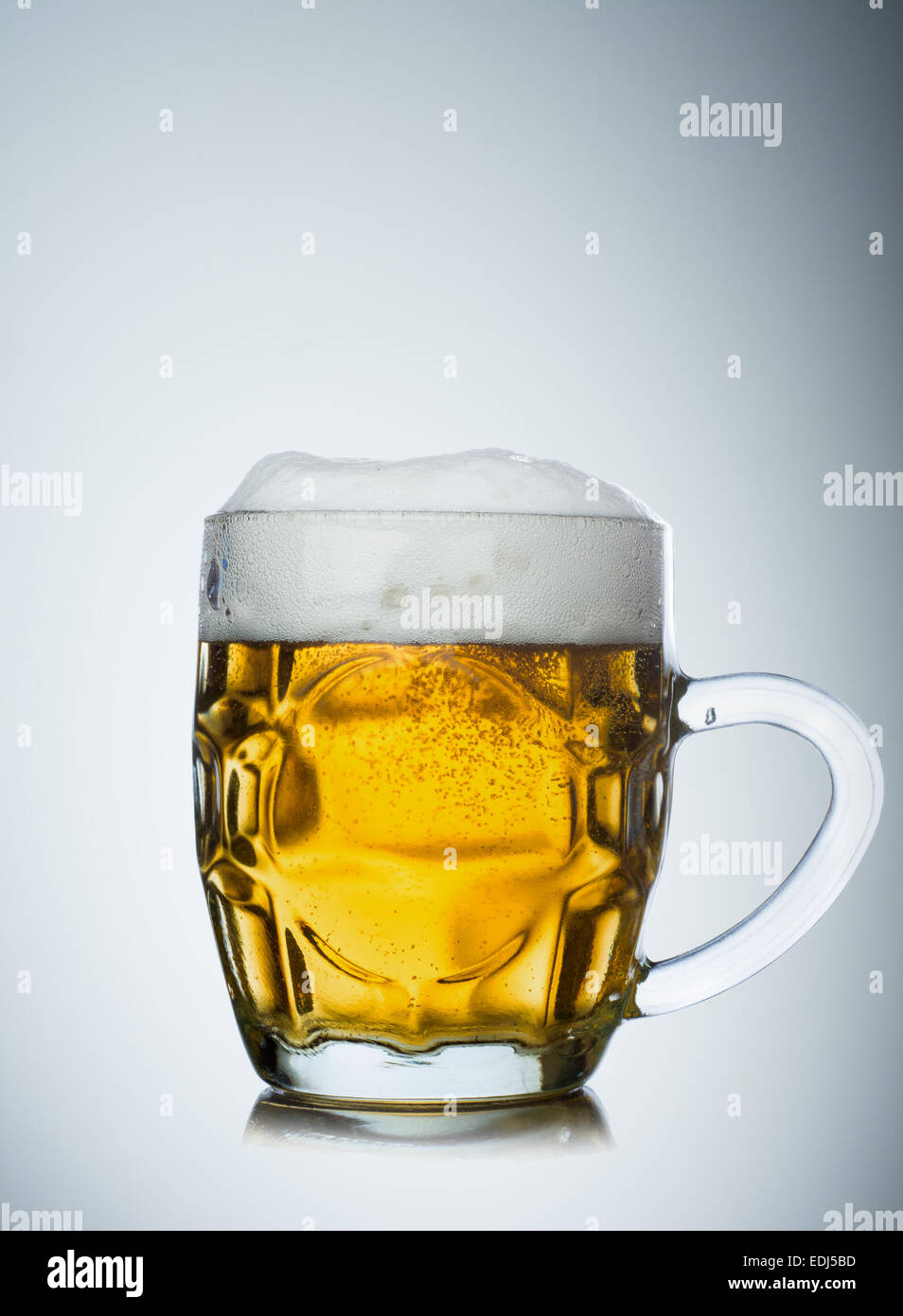 Mug full of fresh beer isolated on white Stock Photo - Alamy