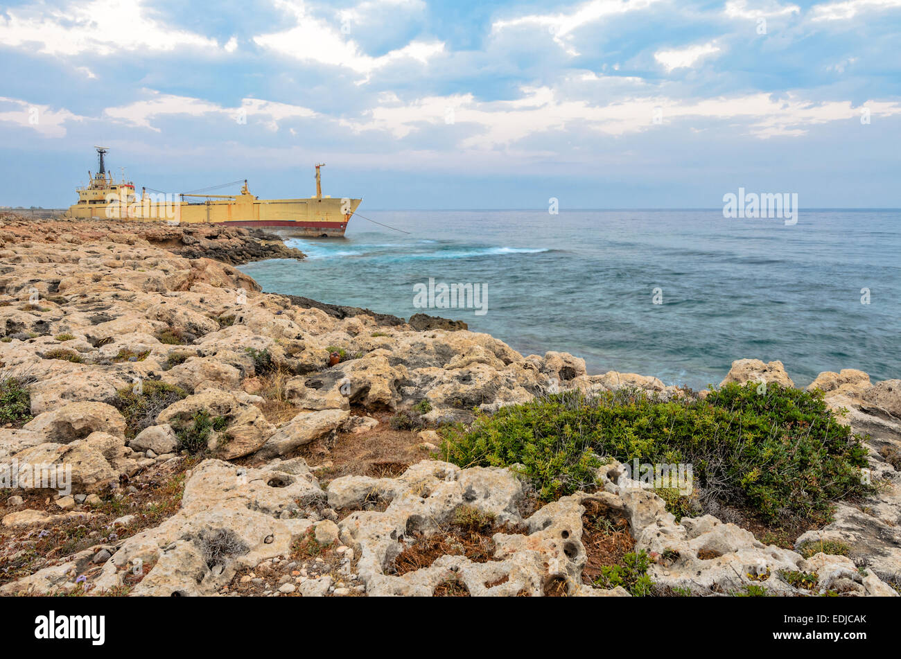 Cargo ship aground near rocky coast Stock Photo - Alamy