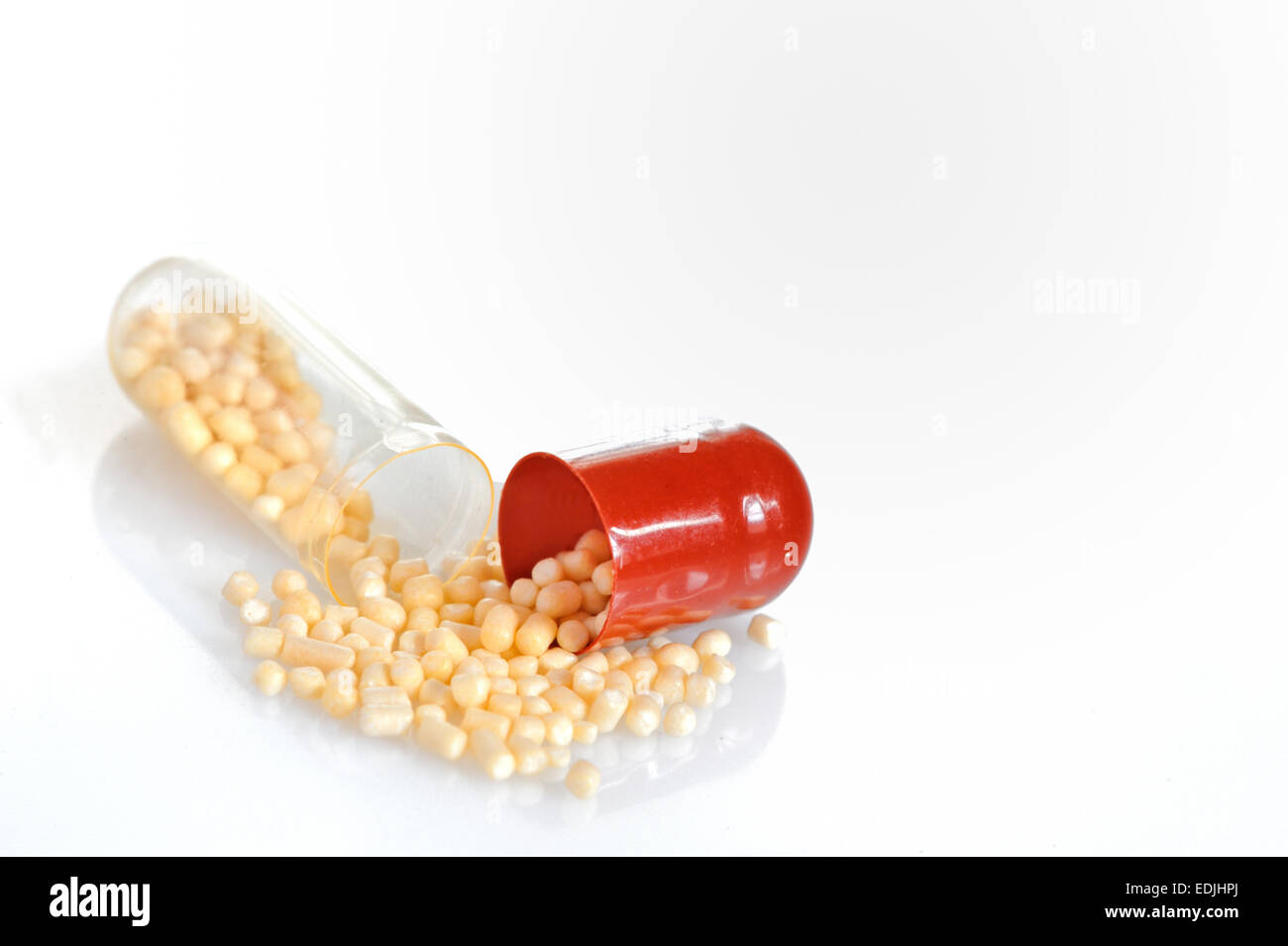 Loose capsule pill on white background Stock Photo - Alamy