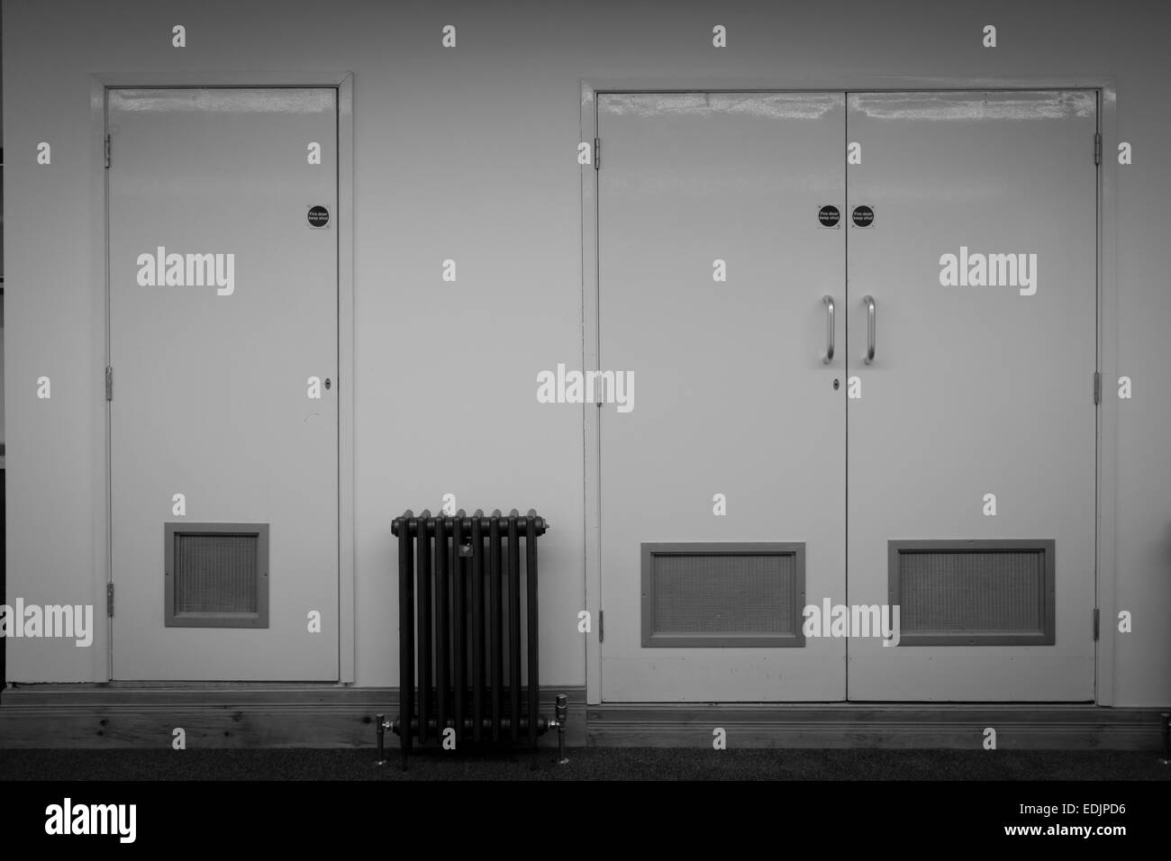 Three Doors to office ventilation plant, with an old fashioned radiator ...