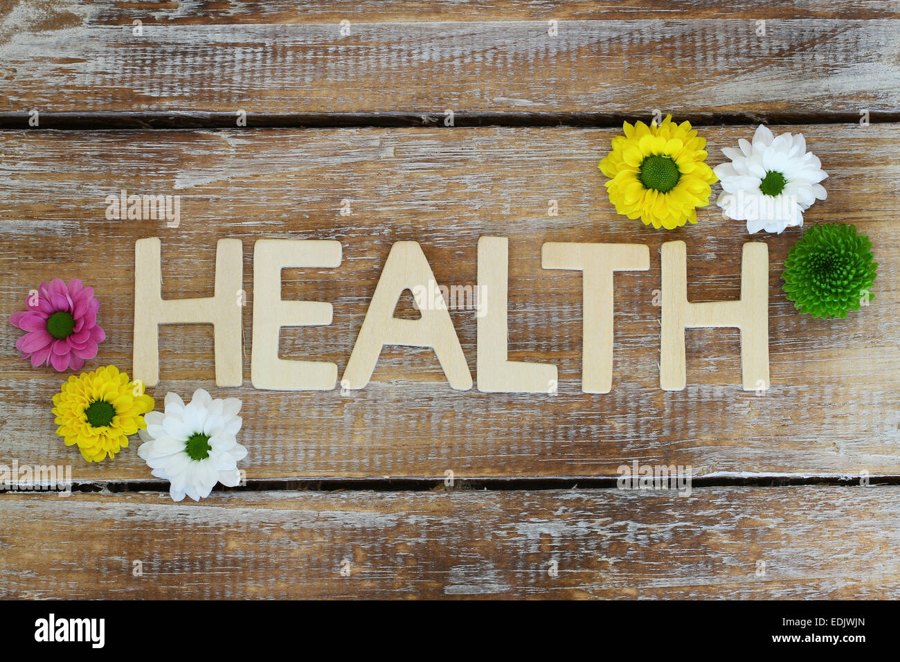 Health written with wooden letters on rustic surface with santini ...