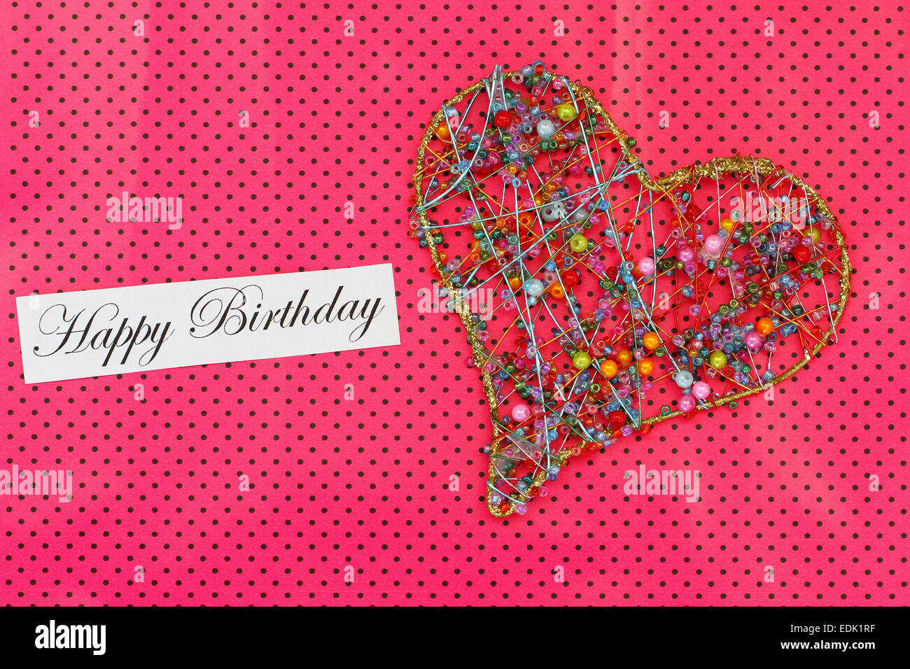 Happy Birthday card with heart made of colorful beads on pink dotty ...