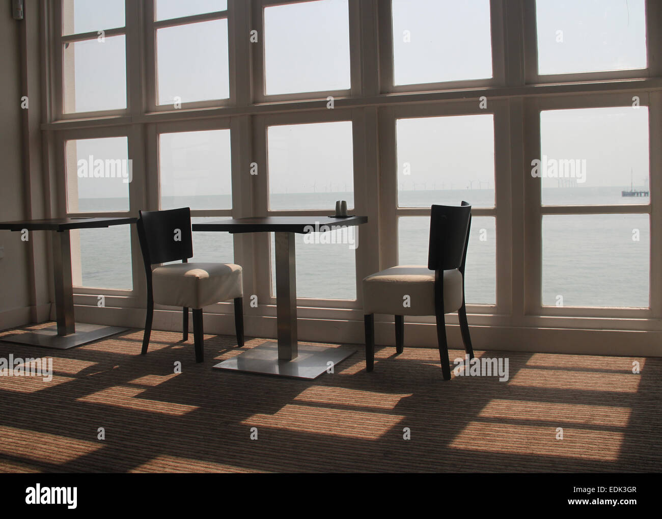 Two chairs and table inside restaurant with view of sea, Clacton-on-Sea ...