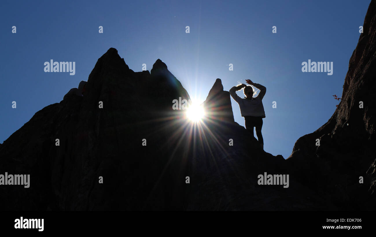 sunset hiker silhouette on rock Flatiron mountains Boulder Colorado ...
