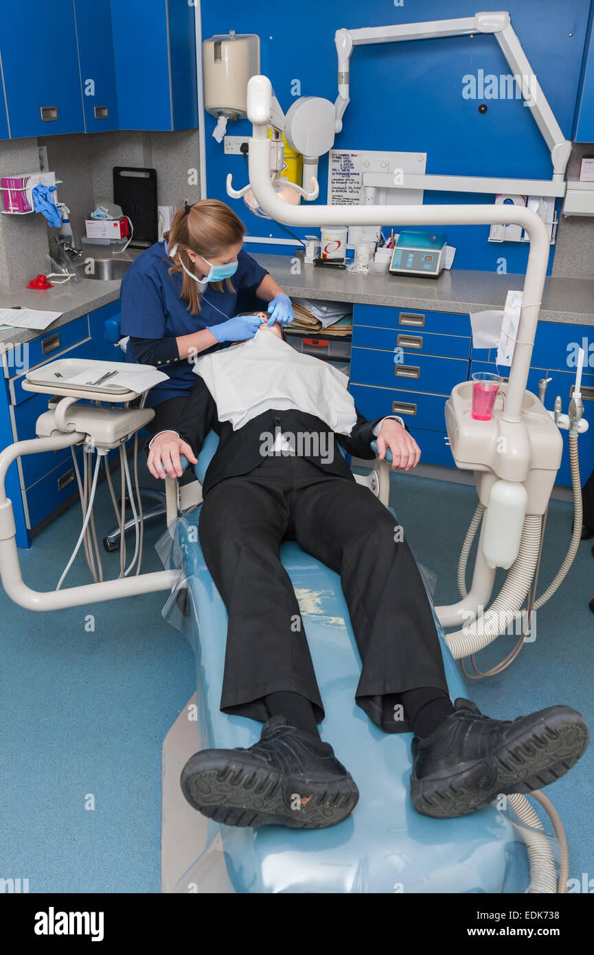 A 14 year old boy having a tooth extracted at the dentists in the Uk ...