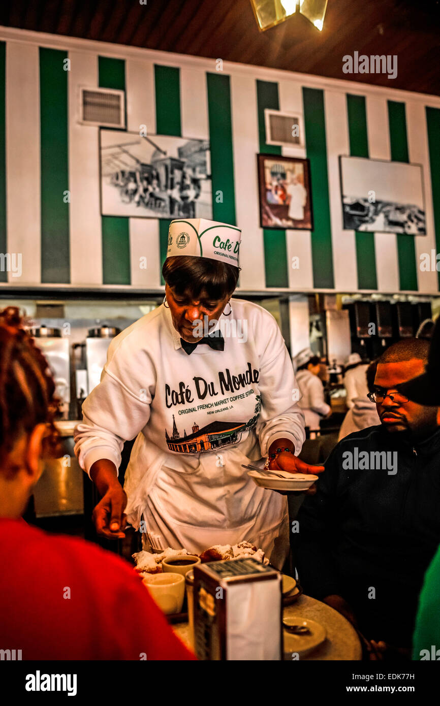 Senior black waitress serves coffee and beignets in the Cafe du Monde ... Senior black waitress serves coffee and beignets in the Cafe du Monde ...