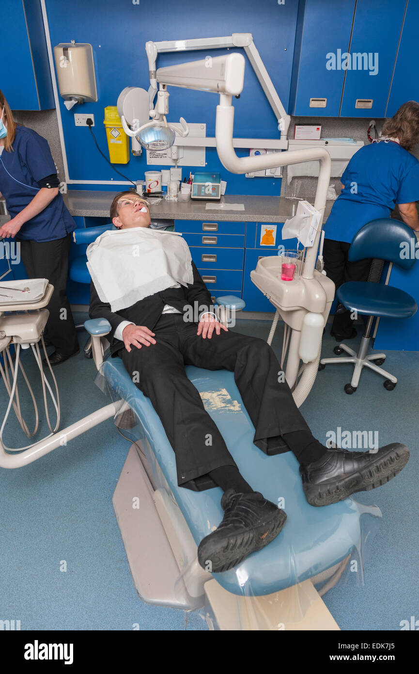 A 14 year old boy having a tooth extracted at the dentists in the Uk ...