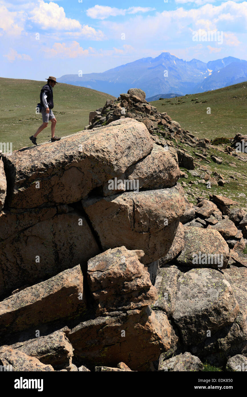 hikers bouldering on weathered granite cliff Rocky Mountain National ...