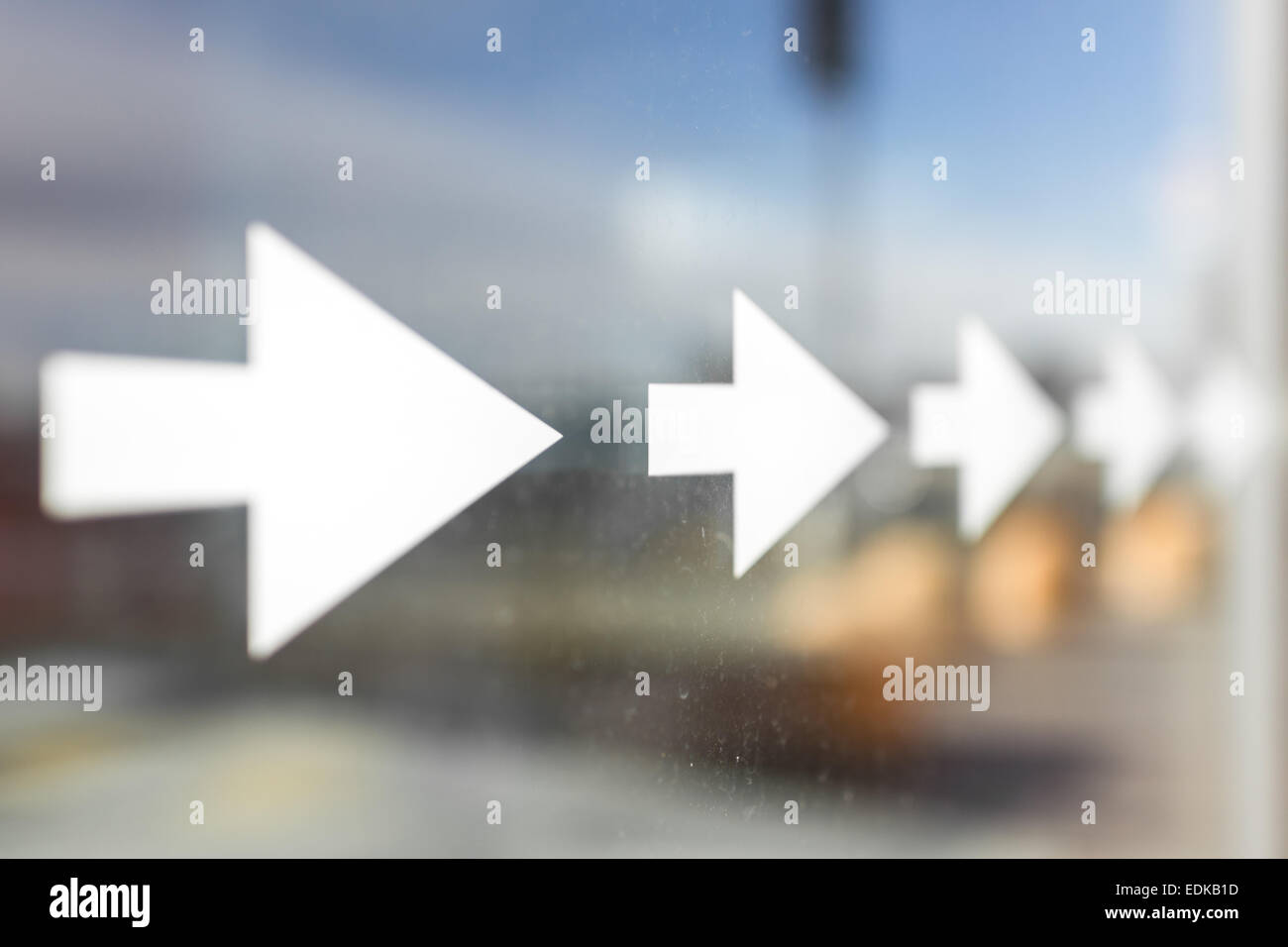 Long row of arrows stickers on a dirty window Stock Photo - Alamy