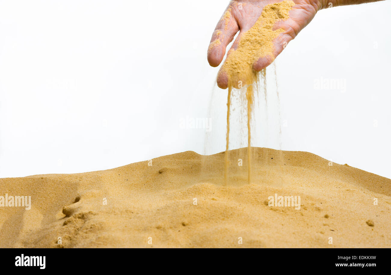 Mans hand with soft sand running through fingers Stock Photo - Alamy