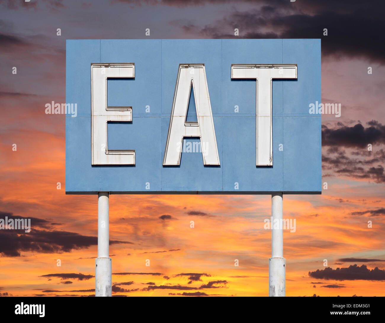 Vintage blue eat sign with sunset sky Stock Photo - Alamy