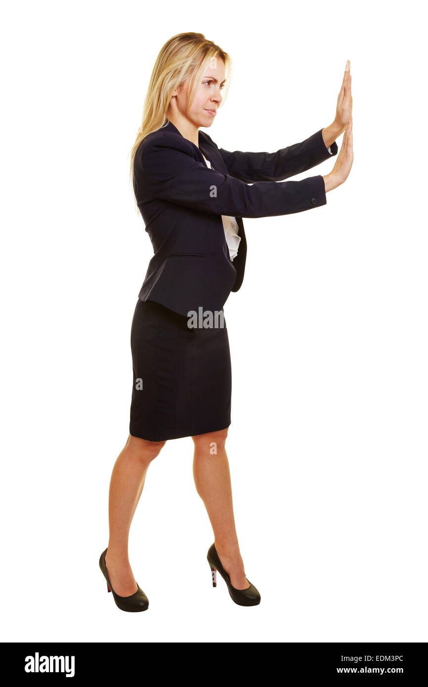 Young businesswoman pushing imaginary object to the side Stock Photo ...