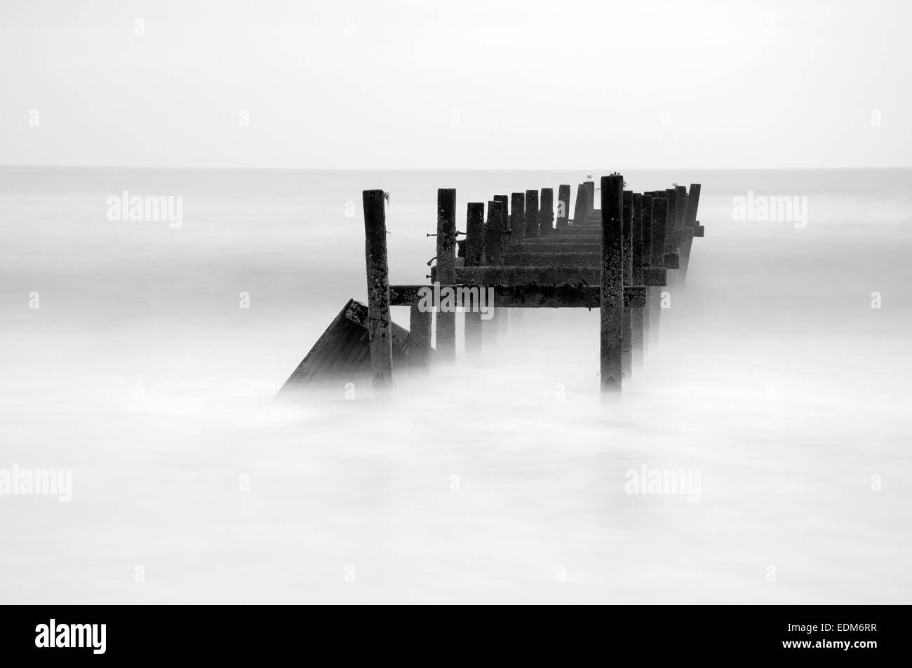 Black and white long exposure of the old sea defences at Happisburgh in ...