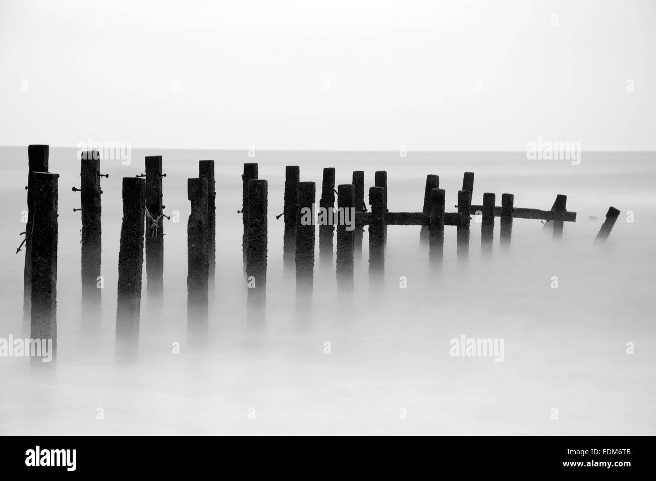 Black and white long exposure of the old sea defences at Happisburgh in ...