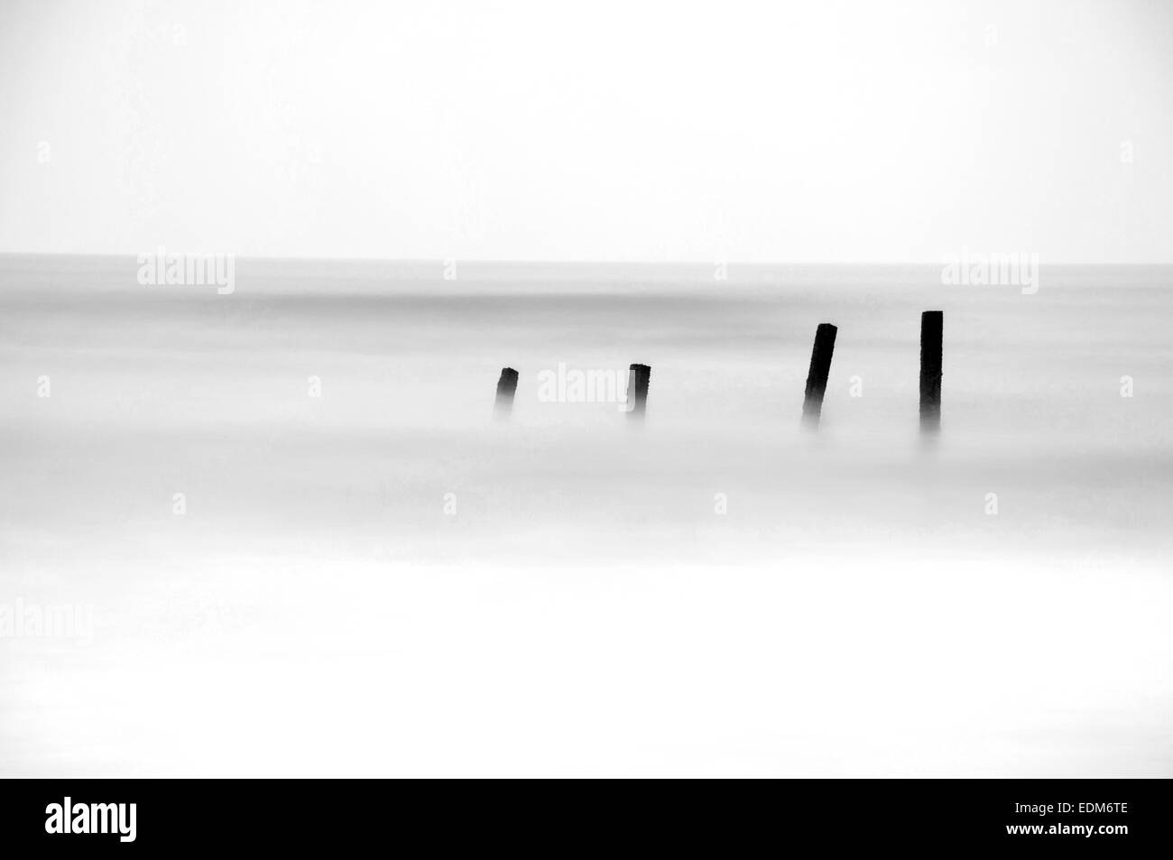 Black and white long exposure of the old sea defences at Happisburgh in ...