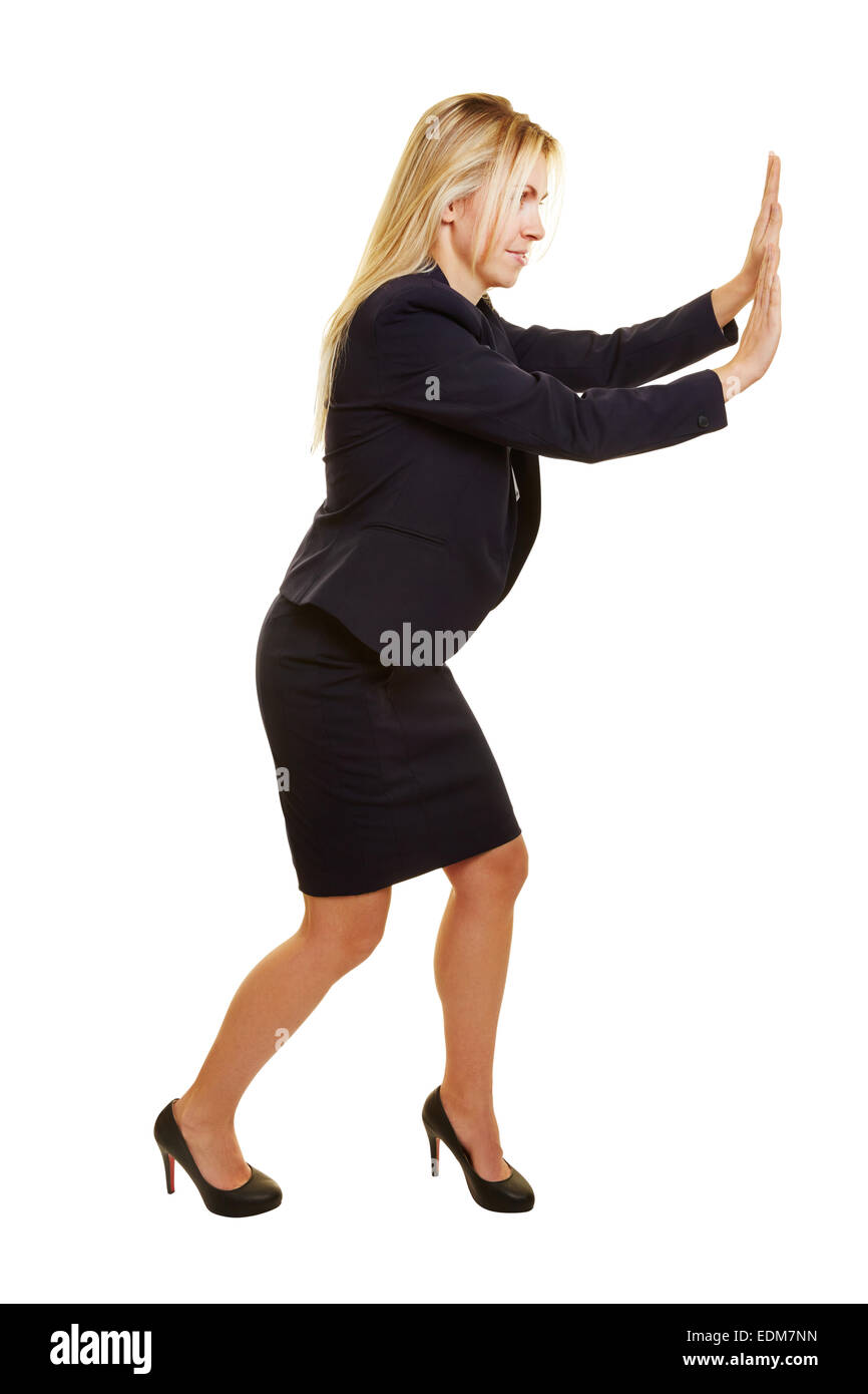 Blonde business woman pushing hard an imaginary wall to the side Stock ...