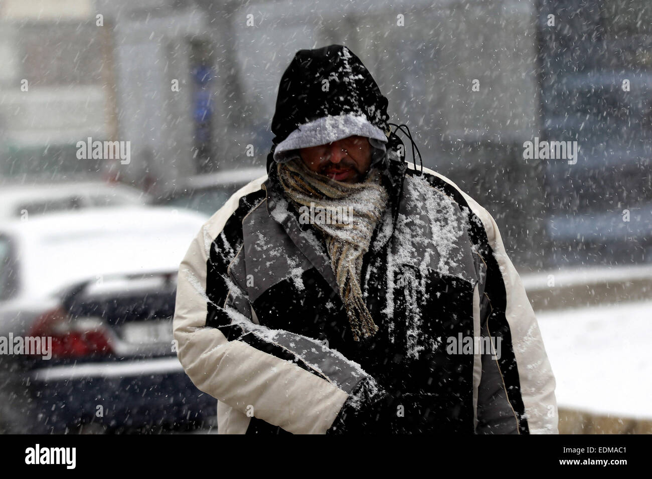 Amman, Jordan. 7th Jan, 2015. A Jordanian man covered with snow walks ...