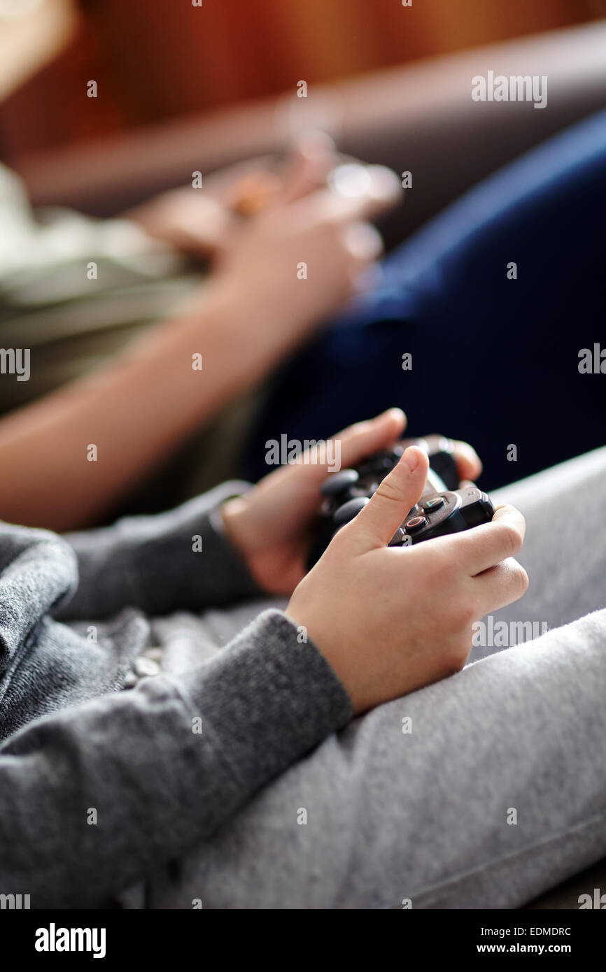 Two friends playing console games, focus on their hands Stock Photo - Alamy