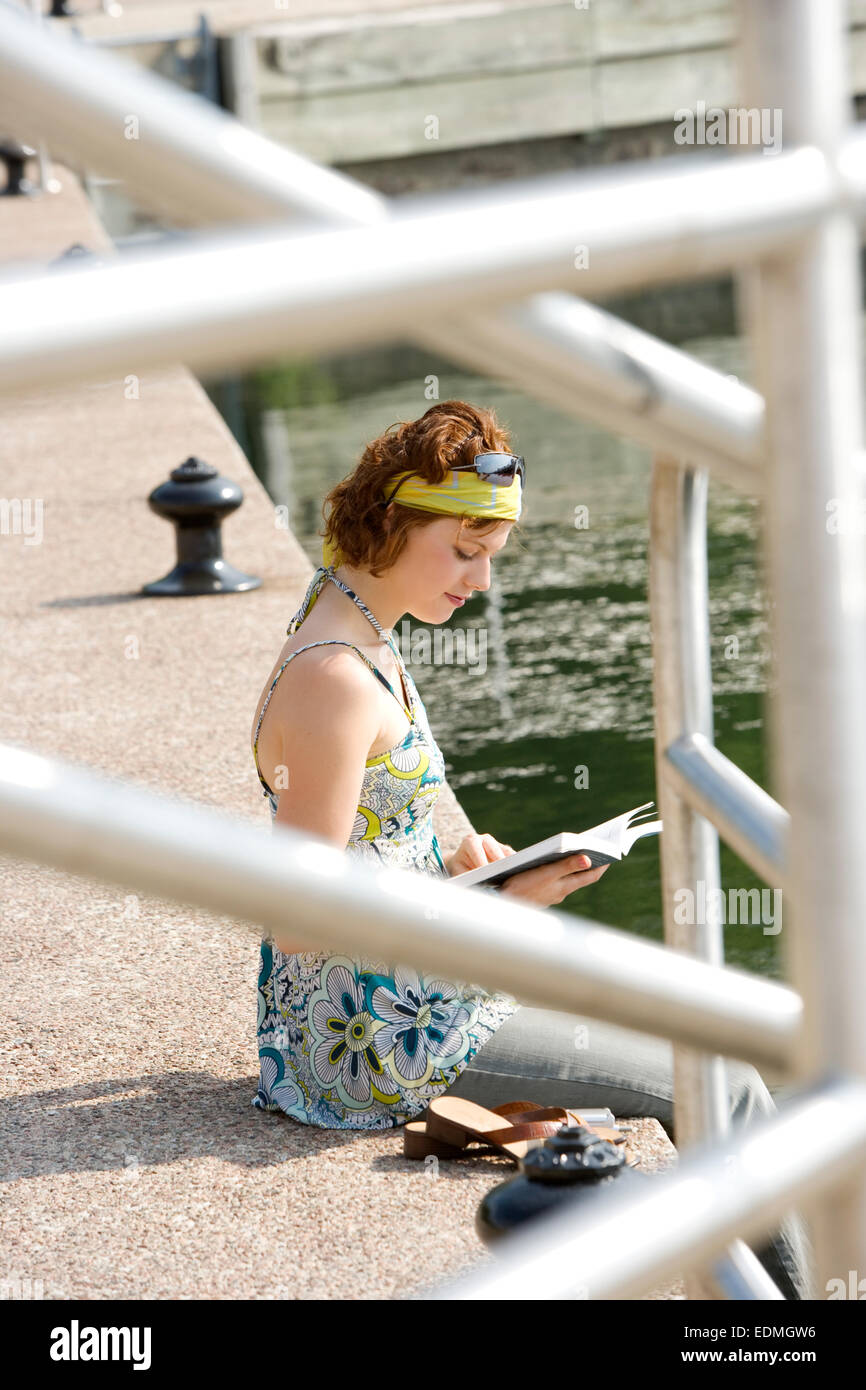 woman reading at marina Stock Photo - Alamy