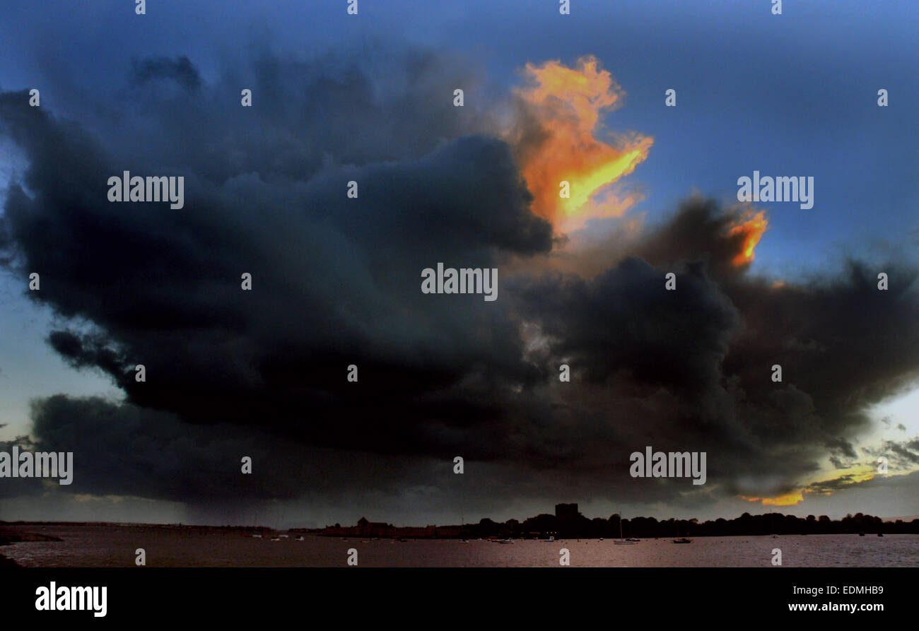 A storm cloud appears to spit fire as it passes over Portchester Castle ...