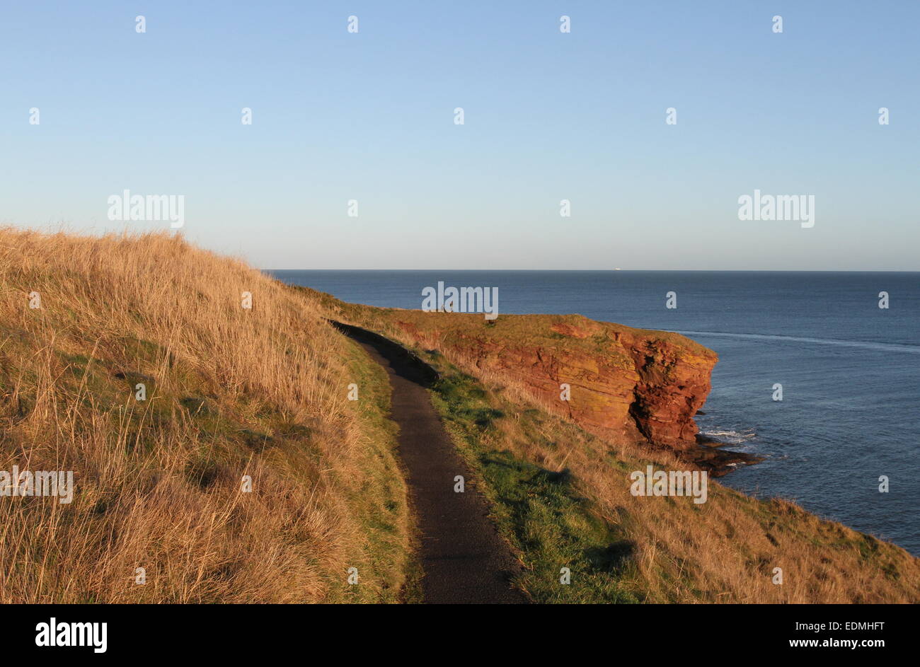 Footpath and red sandstone Seaton Cliffs Angus Scotland January 2015 ...