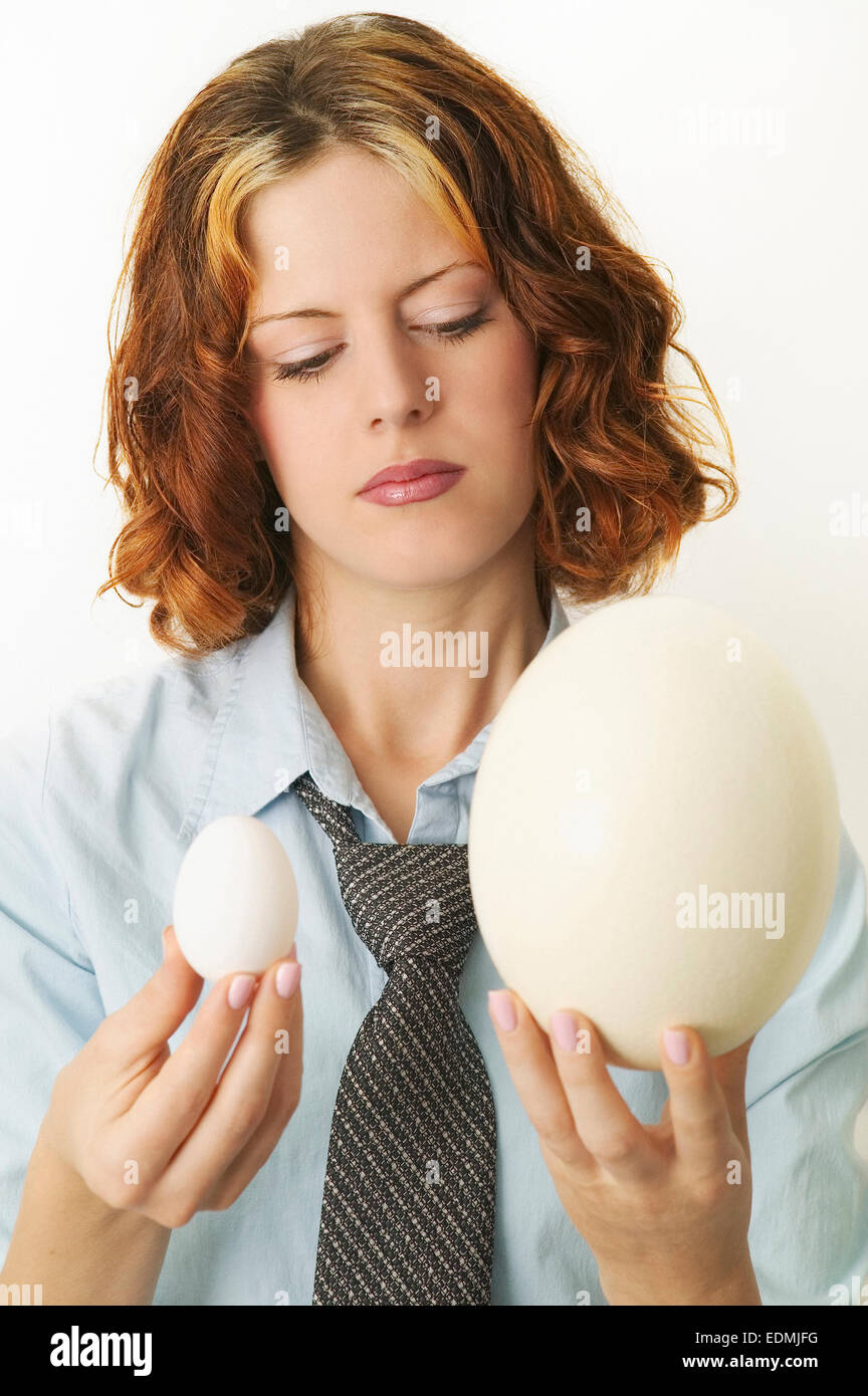 Woman Looking At Two Different Sized Eggs Stock Photo Alamy woman-looking-at-two-different-sized-eggs-stock-photo-alamy